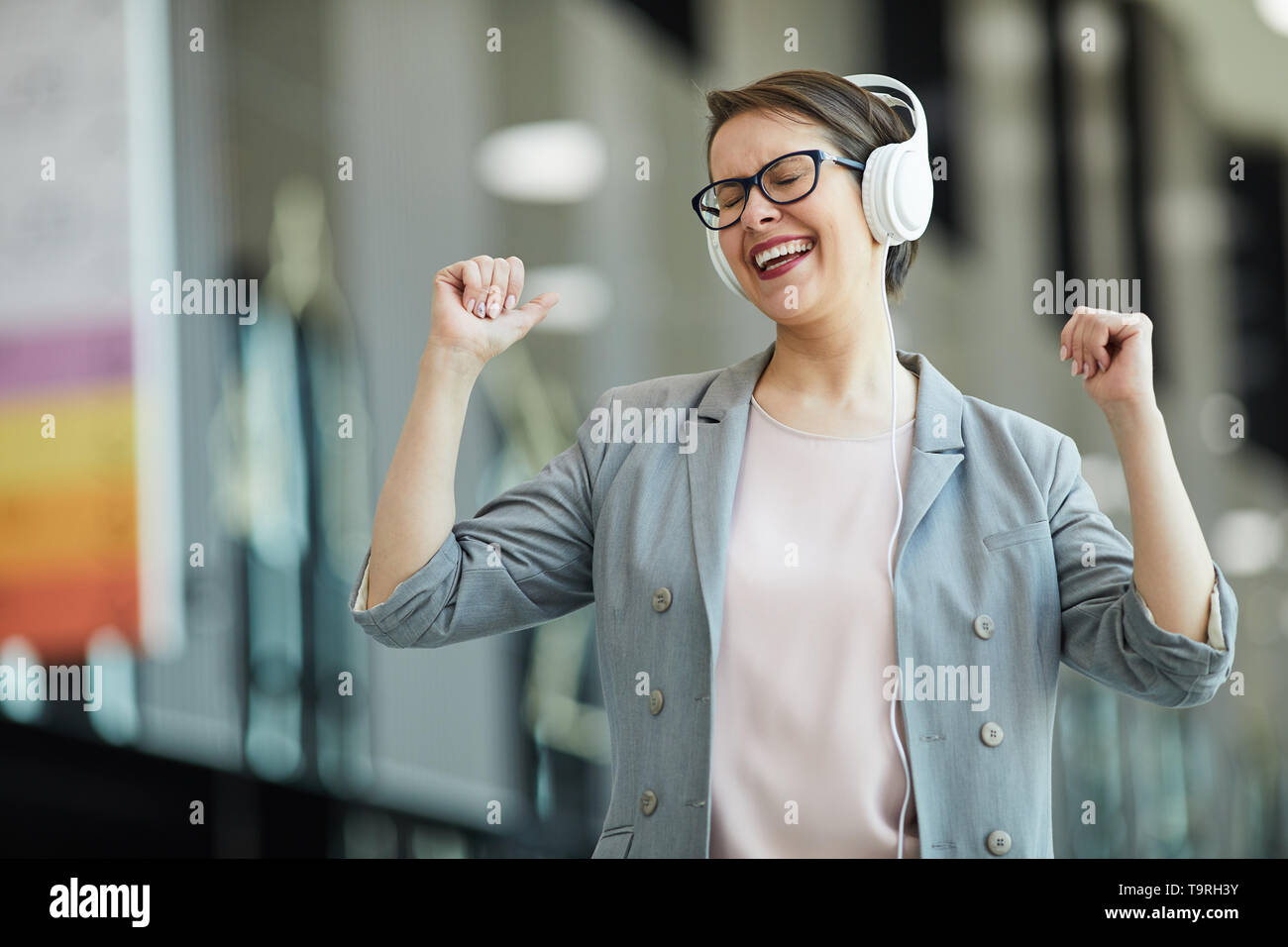 Jolly woman dancing in excitement Stock Photo - Alamy