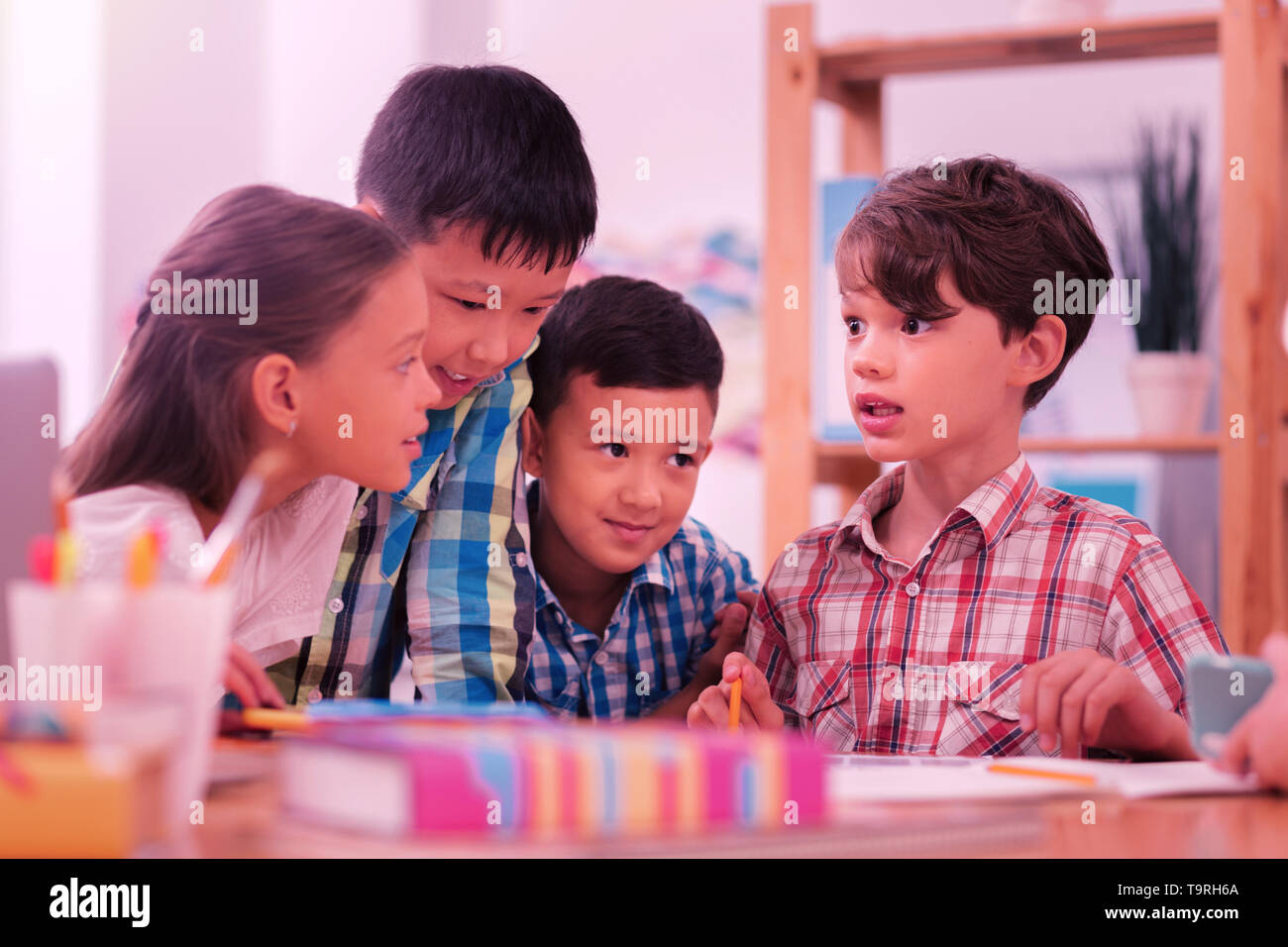 Children at the schooldesk discussing their exercises Stock Photo - Alamy
