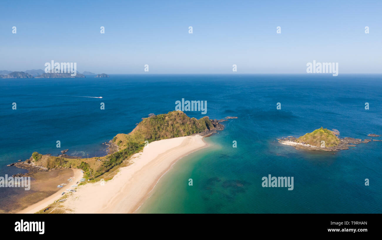 Wide tropical beach with white sand and small islands, top view. Nacpan ...