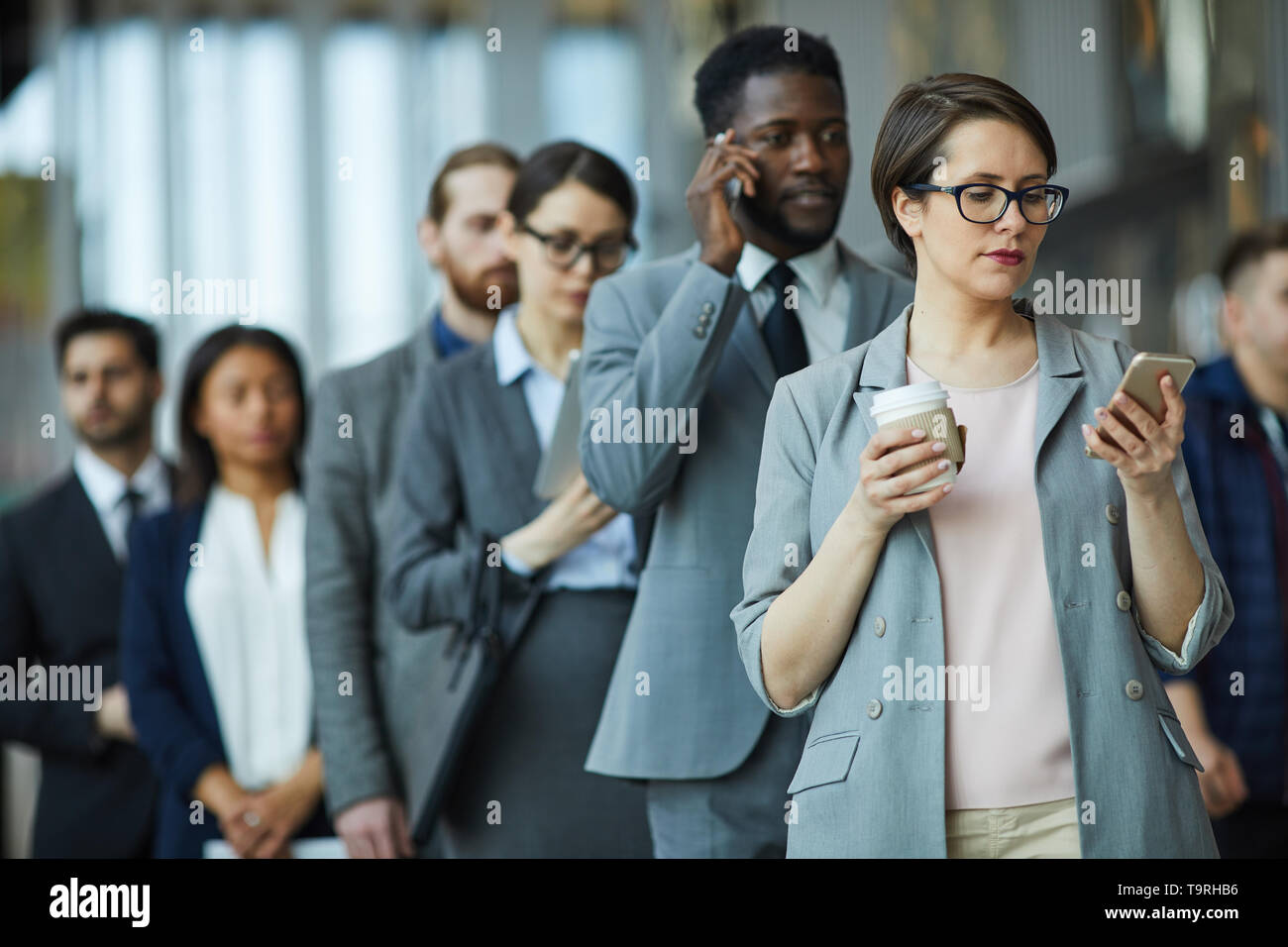 Entrepreneurs standing in line Stock Photo - Alamy