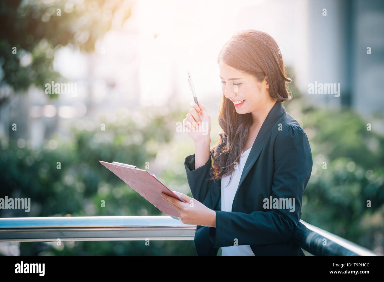 Portrait of business woman happy smile holding check list on clipboard ...