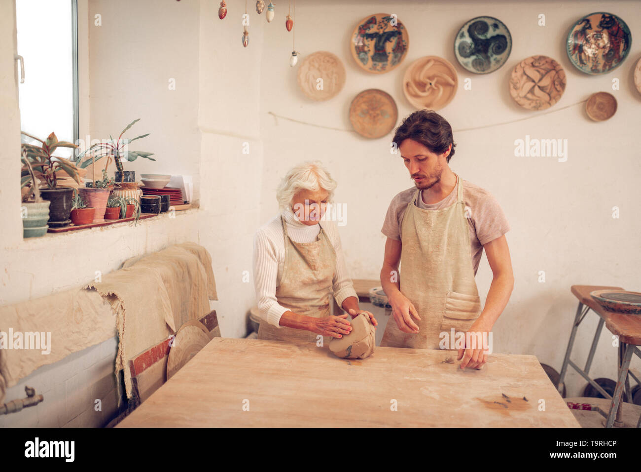 Nice young man looking at the master Stock Photo - Alamy