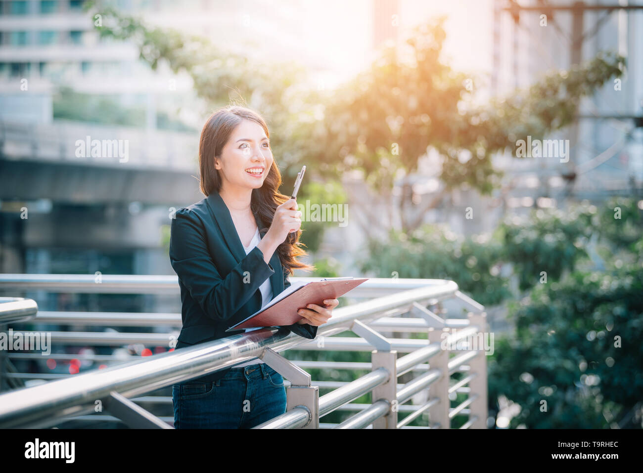 Portrait of business woman happy smile holding check list on clipboard ...