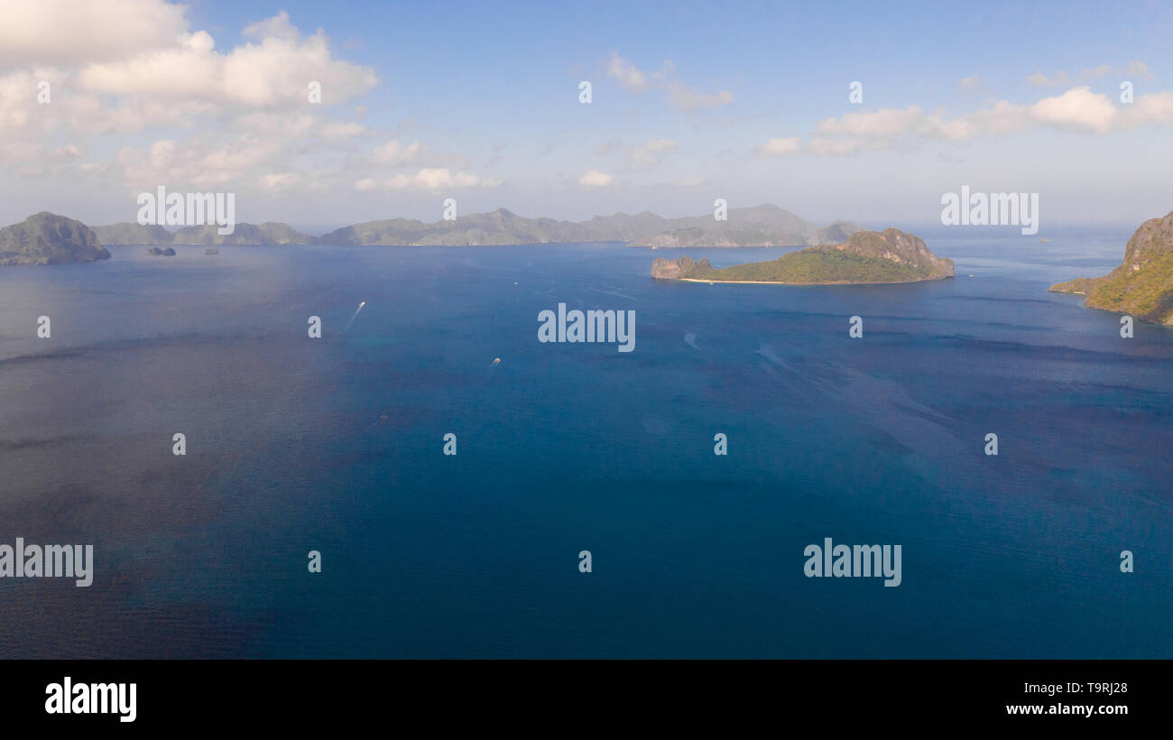 Seascape, view from above. Rocky islands covered with rainforest. El ...
