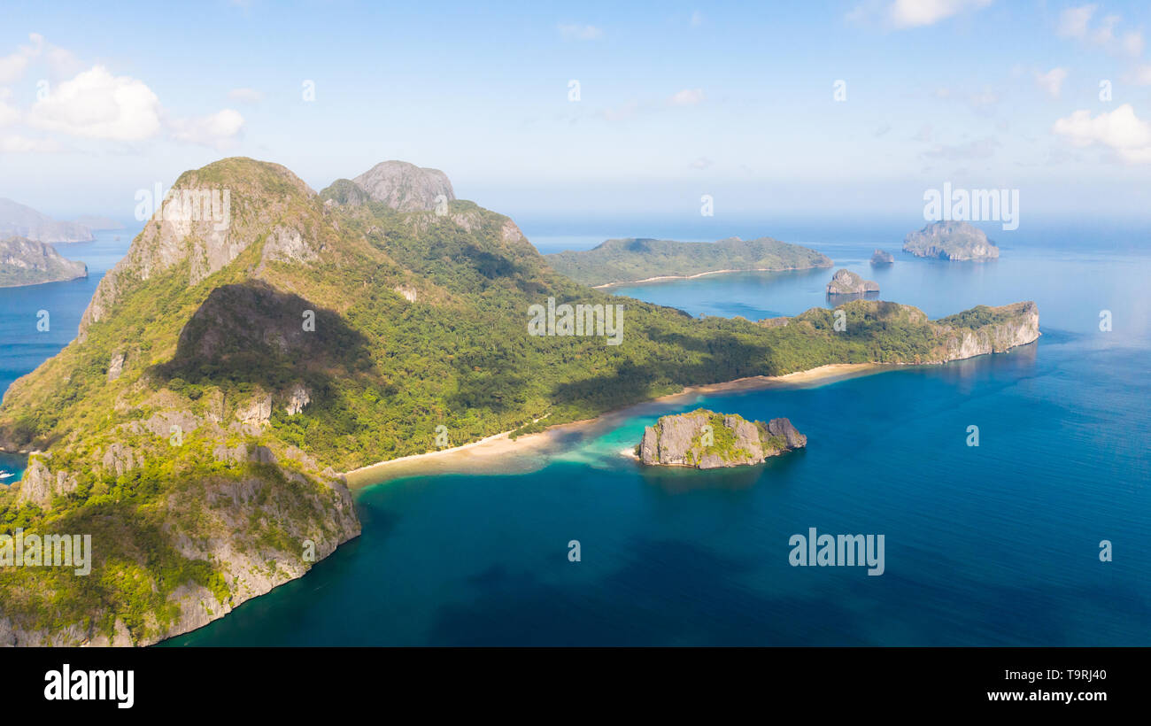 Seascape, view from above. Rocky islands covered with rainforest. El ...