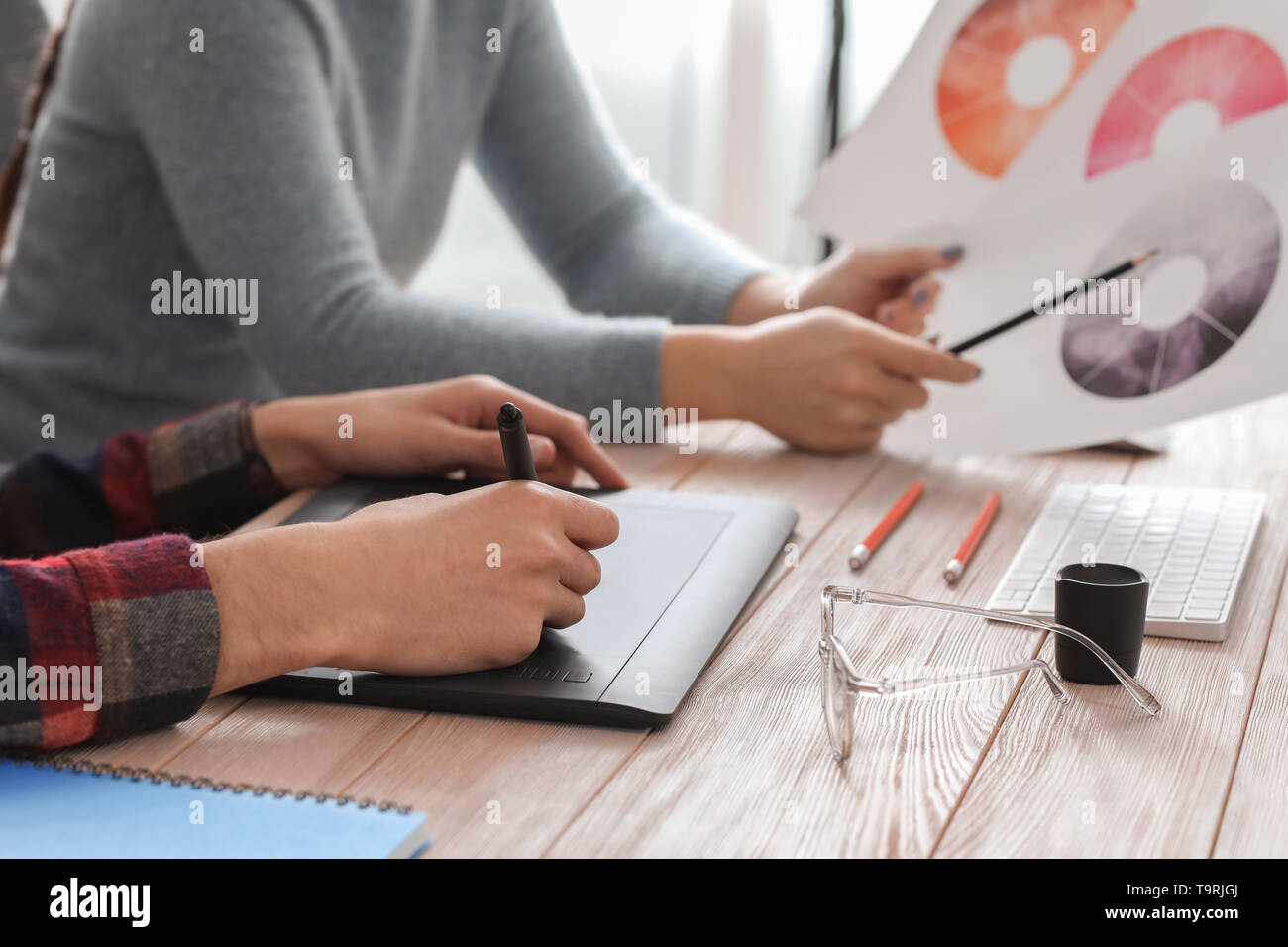 Young designers working in studio Stock Photo - Alamy