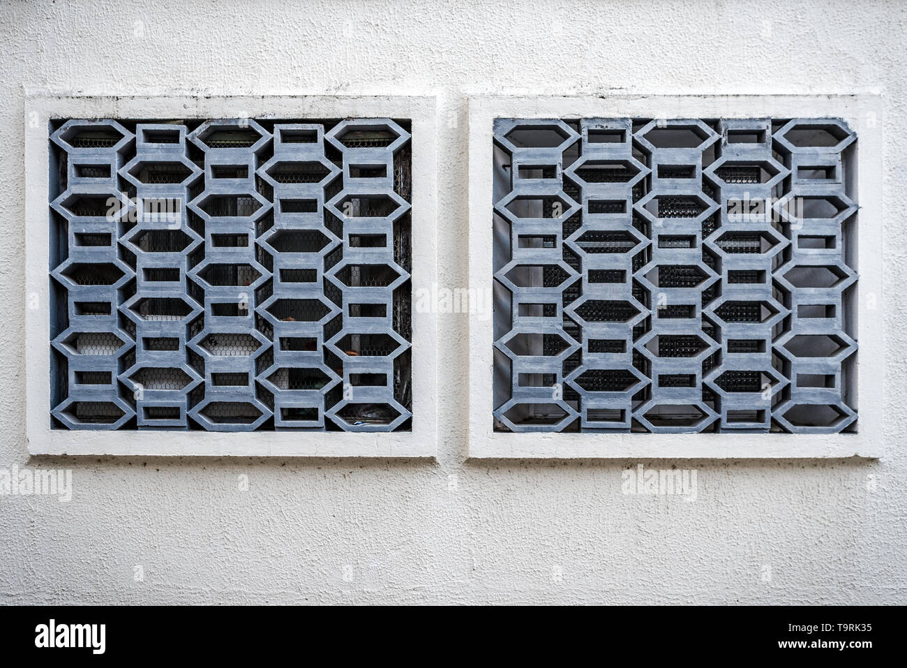 Black square and hexagon pattern block window shutters covering mesh ...