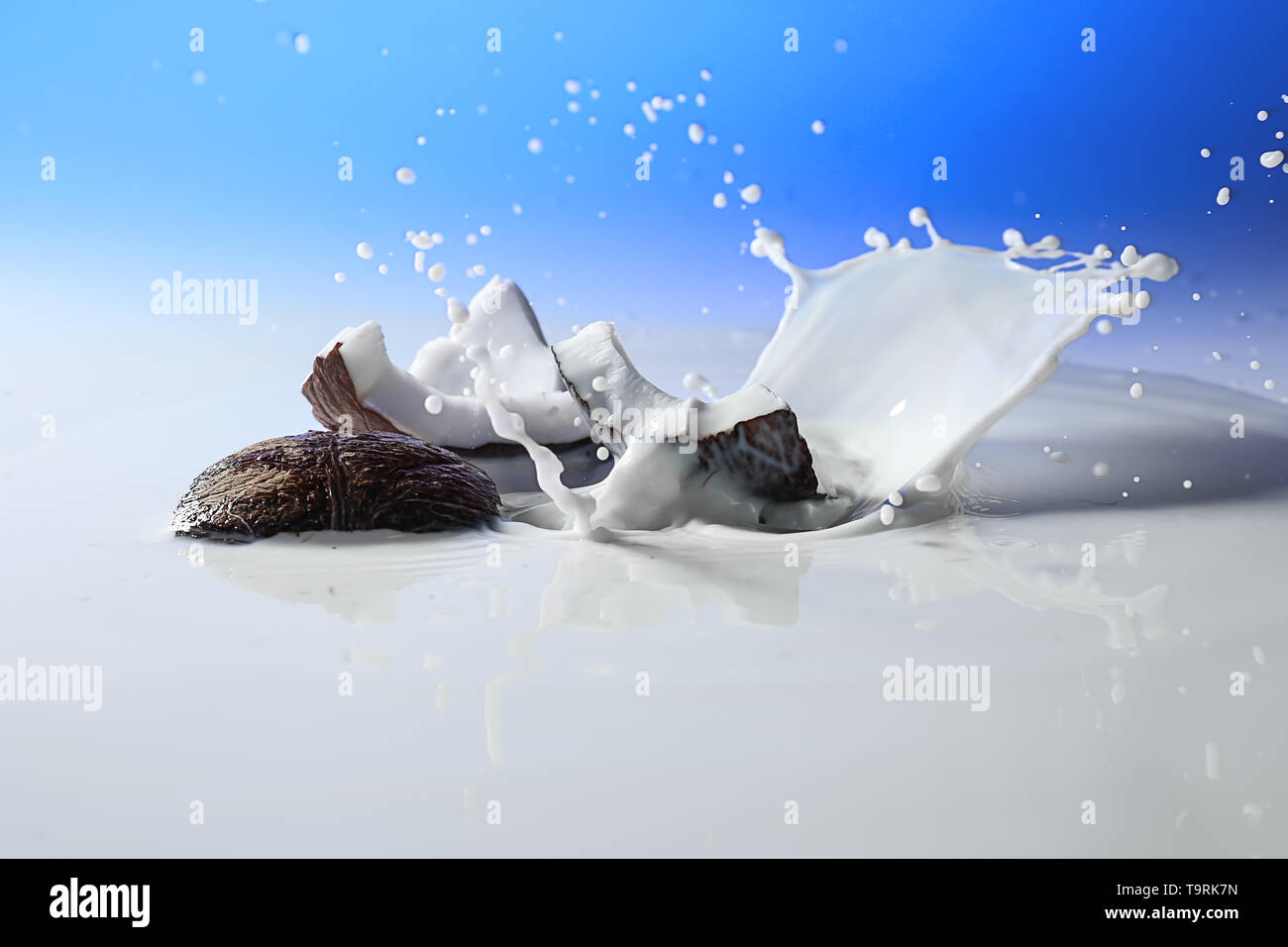 Throwing of coconut pieces into milk Stock Photo - Alamy