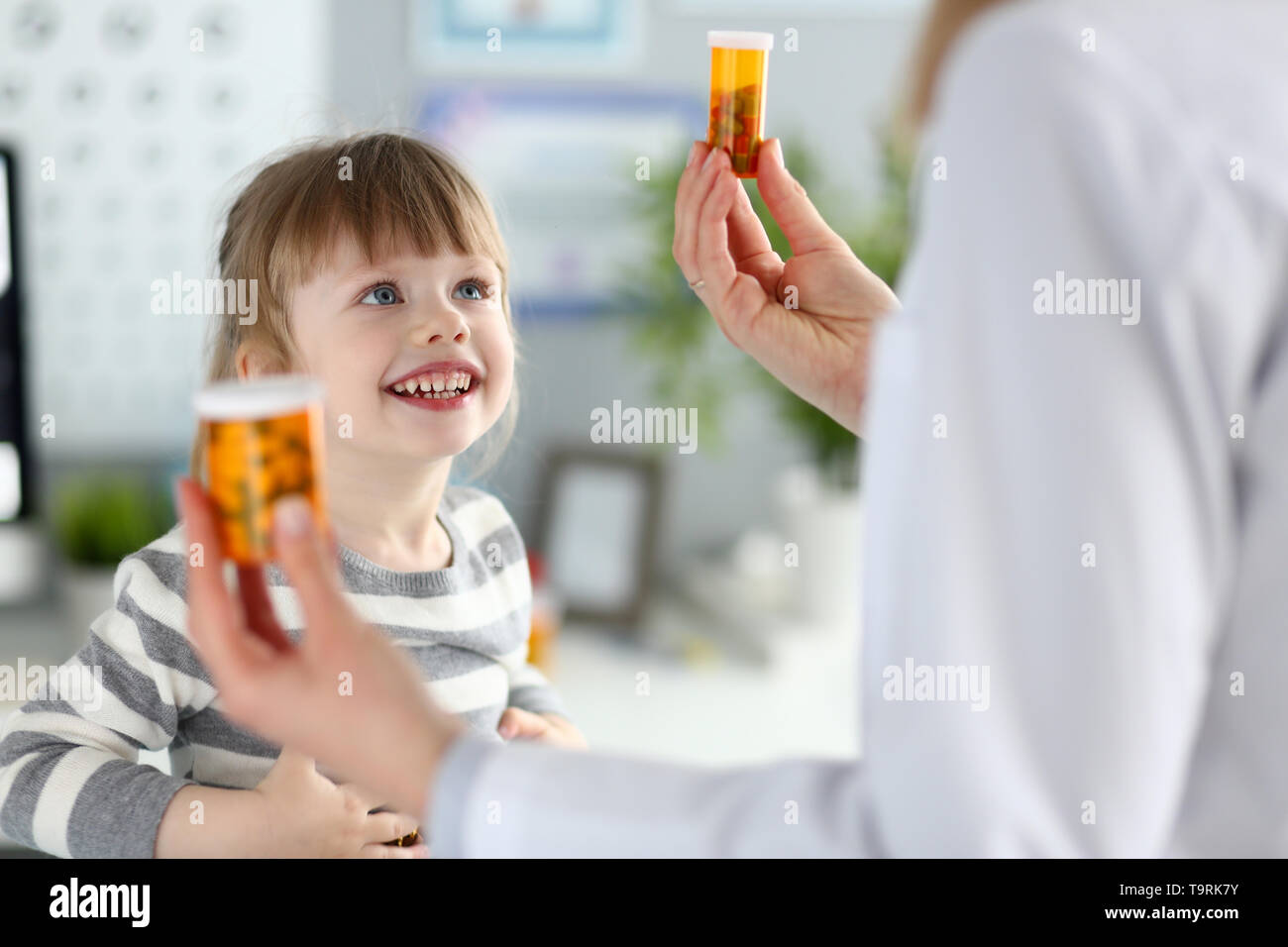 Cute little girl at doctor reception getting medications prescription ...