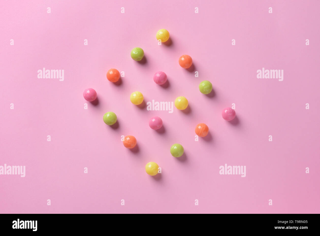 Bright tasty candies on color background Stock Photo - Alamy