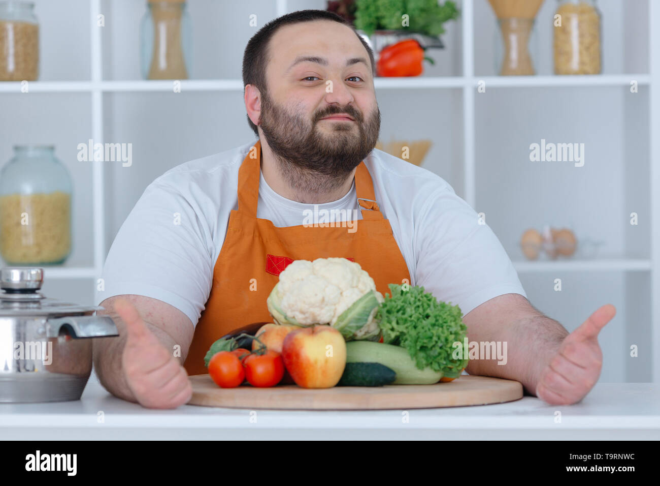 Householder posing at kitchen Stock Photo - Alamy