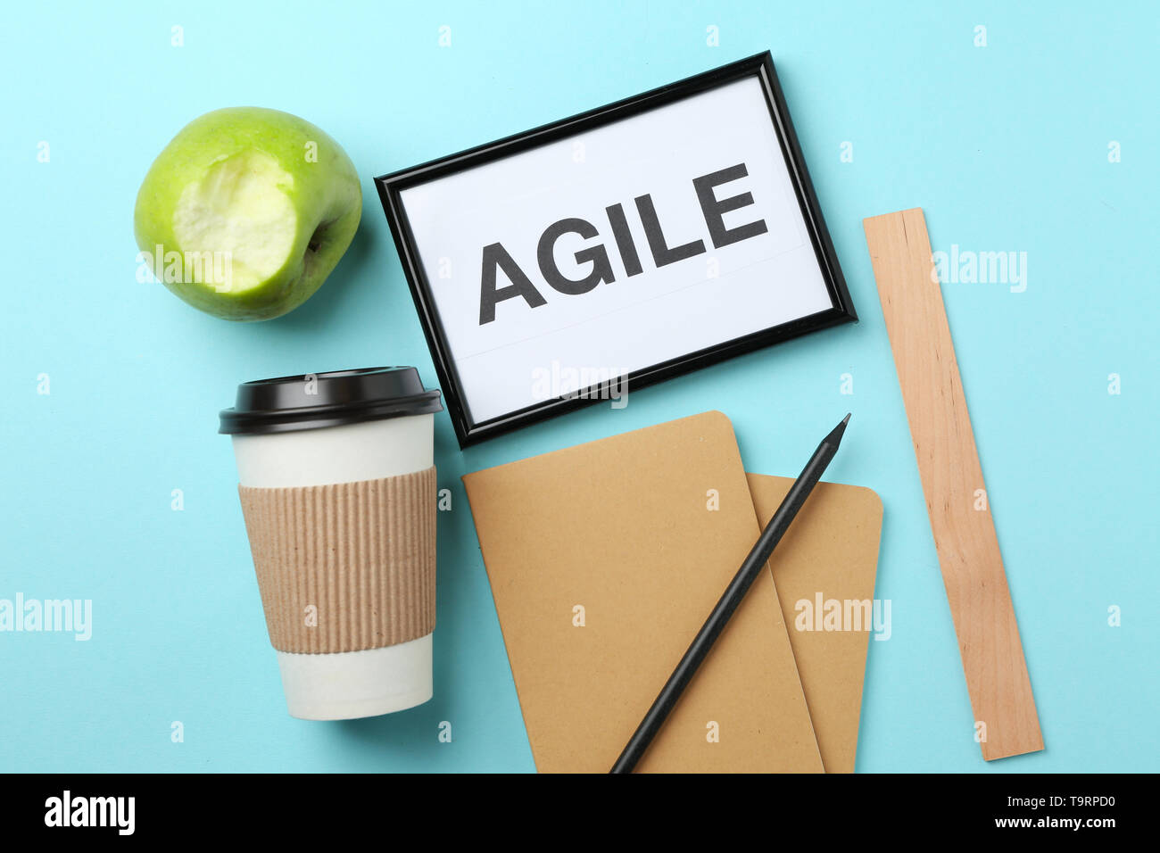 Word AGILE, notebooks, apple and cup of coffee on color background ...