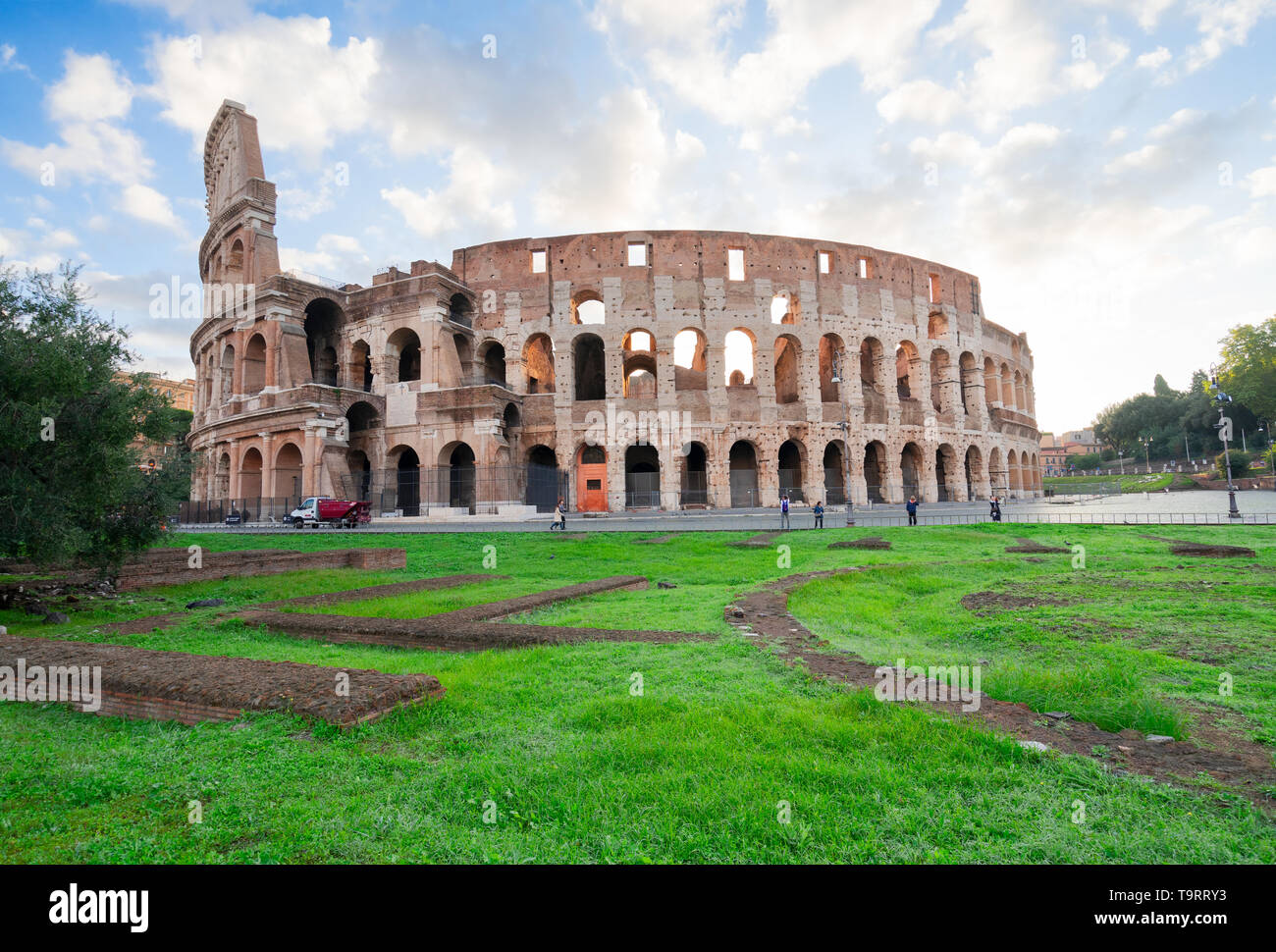 ruins of antique Colosseum building with grass lawn, Rome Italy Stock ...