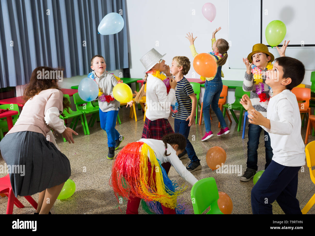 Happy laughing pupils of primary school having fun during festive event ...