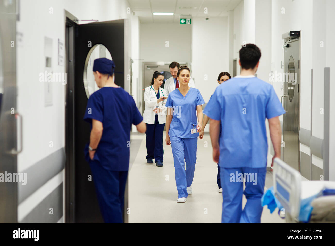 Doctors walking through corridor in hospital Stock Photo - Alamy