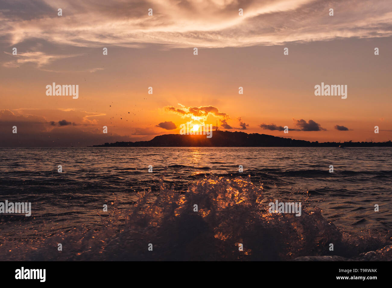 Sunset at the sea, dramatic sky, indonesia Stock Photo - Alamy
