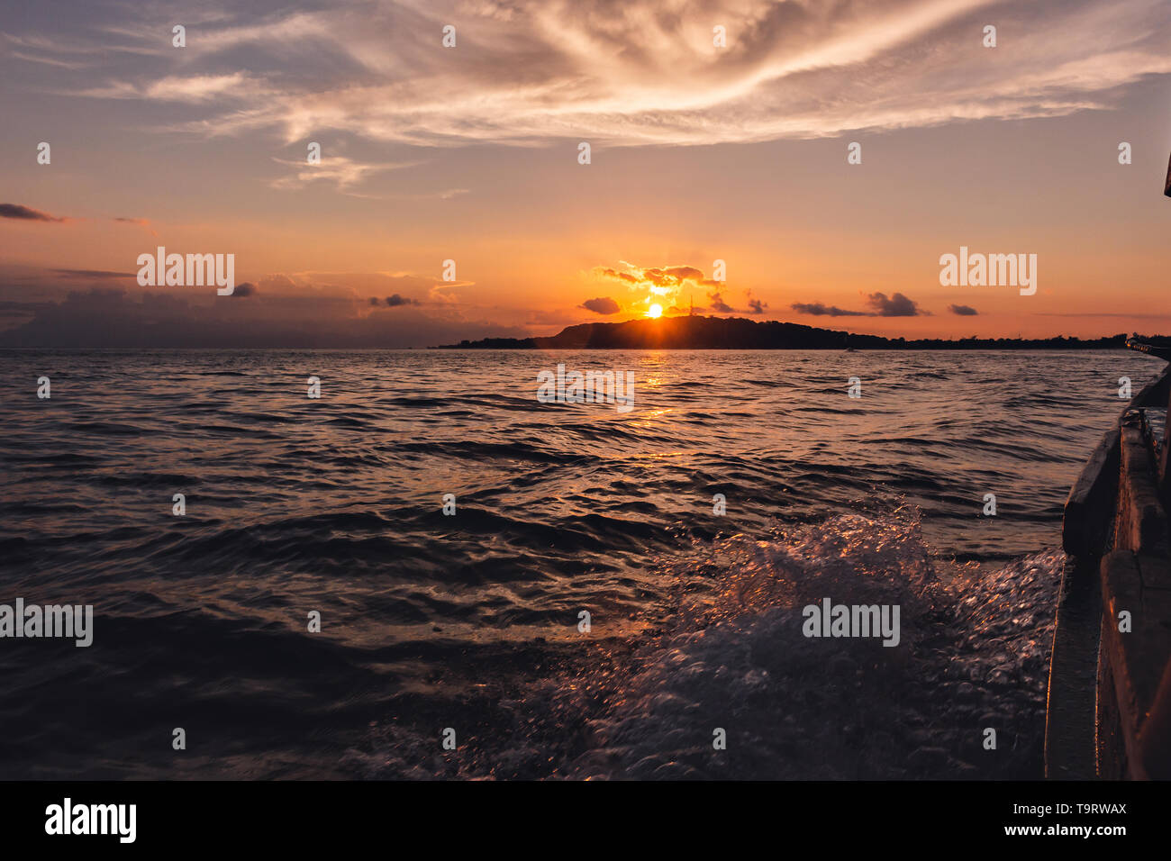 Sunset at the sea, dramatic sky, indonesia Stock Photo - Alamy