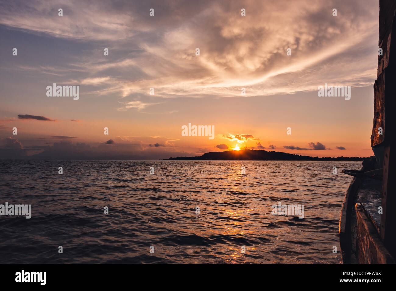 Sunset at the sea, dramatic sky, indonesia Stock Photo - Alamy