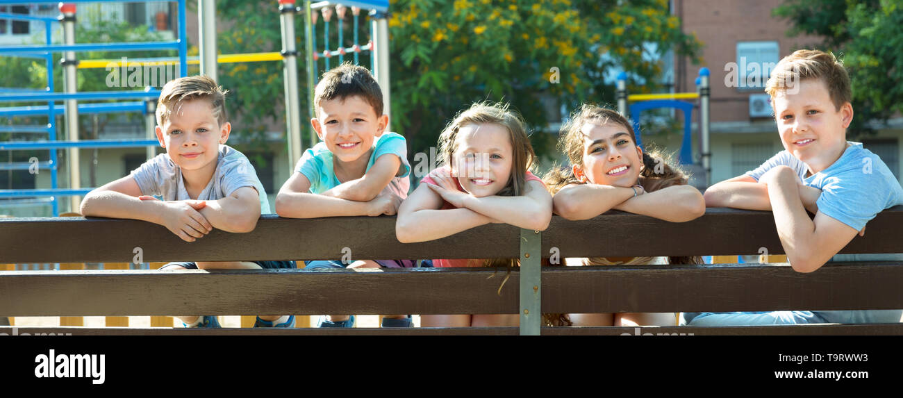 Five children sitting on the bench Stock Photo - Alamy
