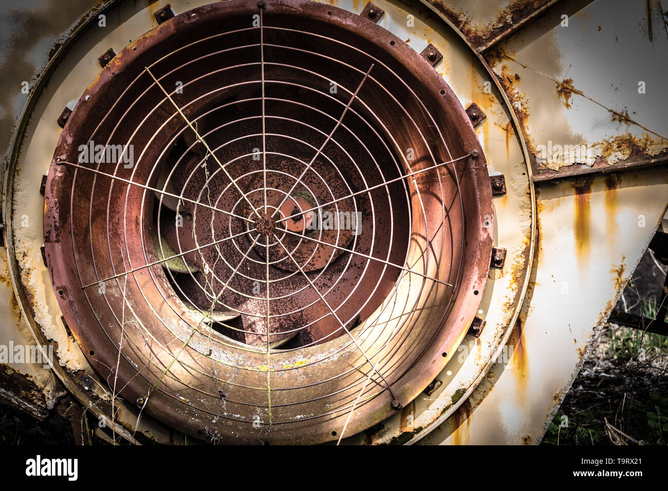 Old rusted grid in farm machinery in an abandoned old building in ...