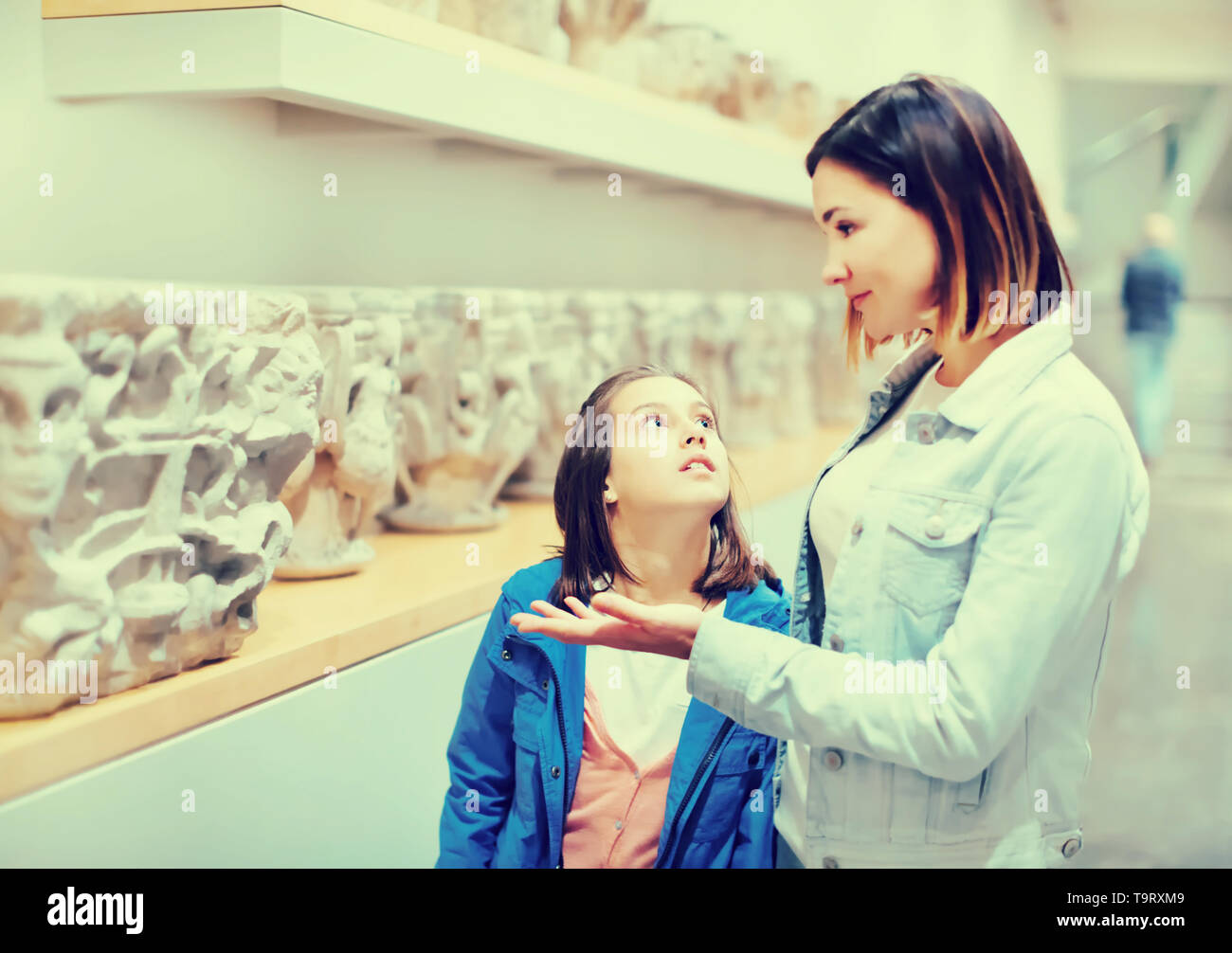 Young mother and daughter exploring old bas-reliefs in the museum ...
