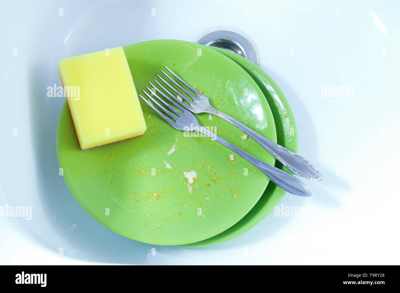 Green dirty plates with leftover food. In a white car wash. View from ...