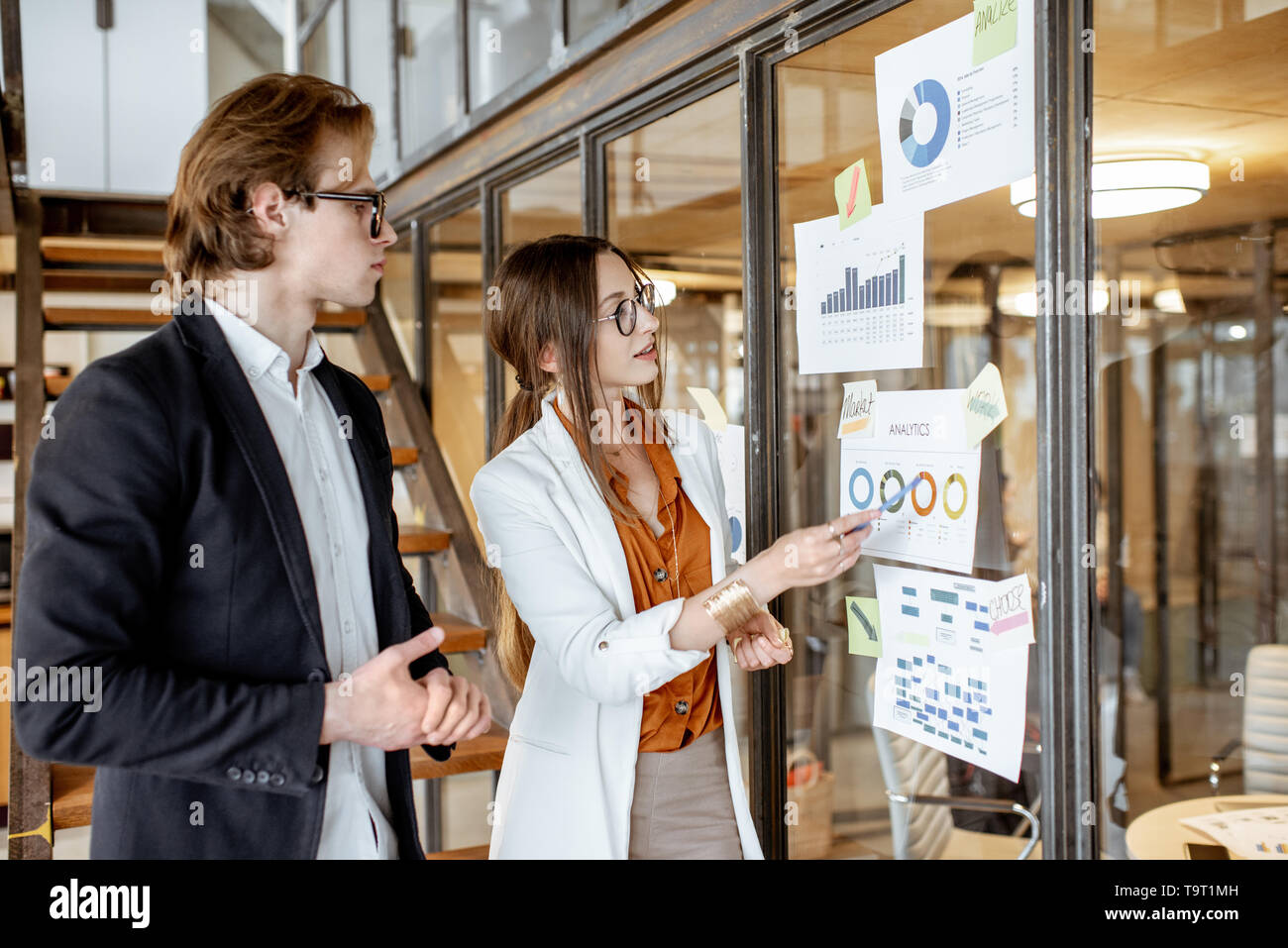 Business people having a discussion while working with charts and ...