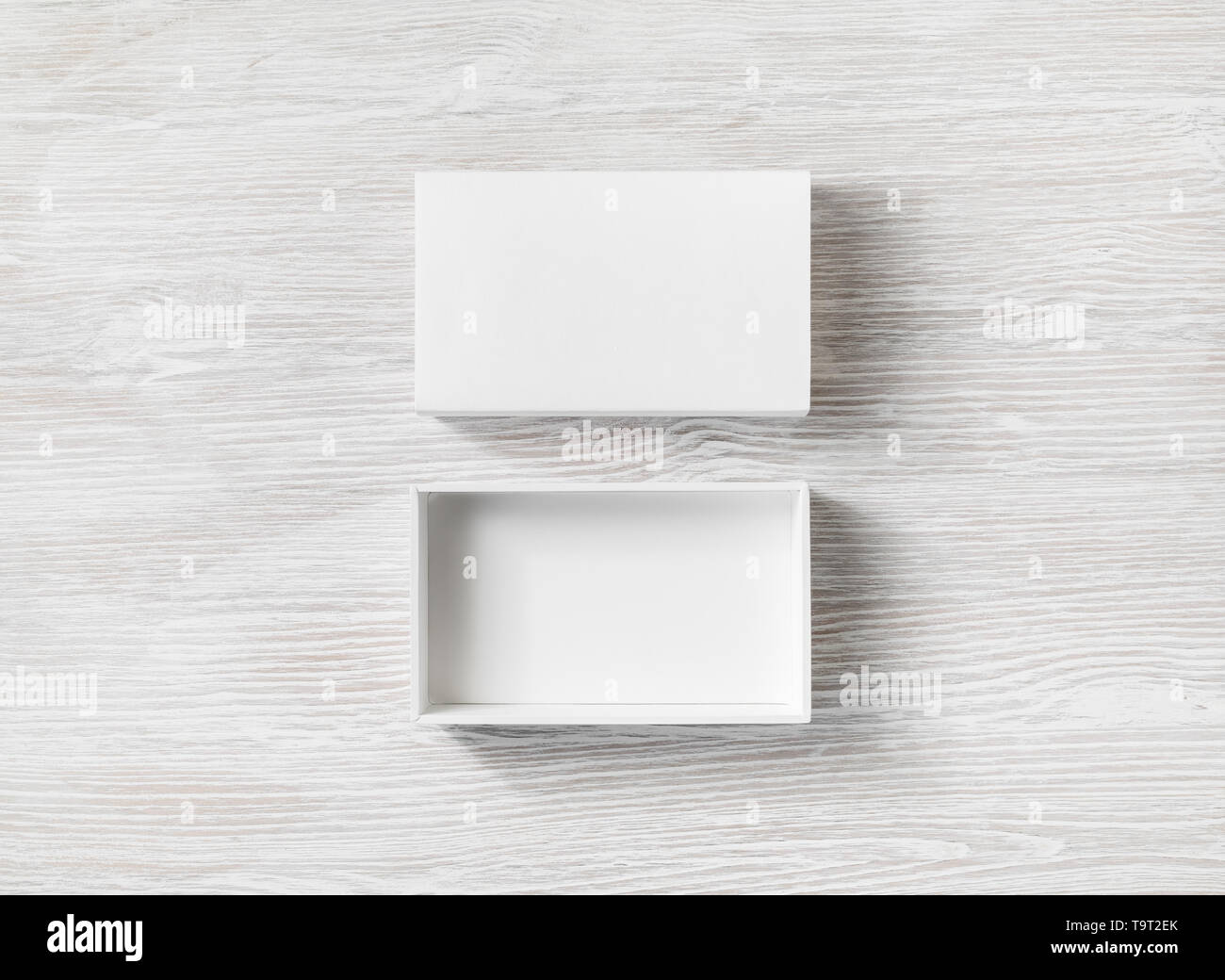 White cardboard box with cover on light wooden background. Flat lay ...