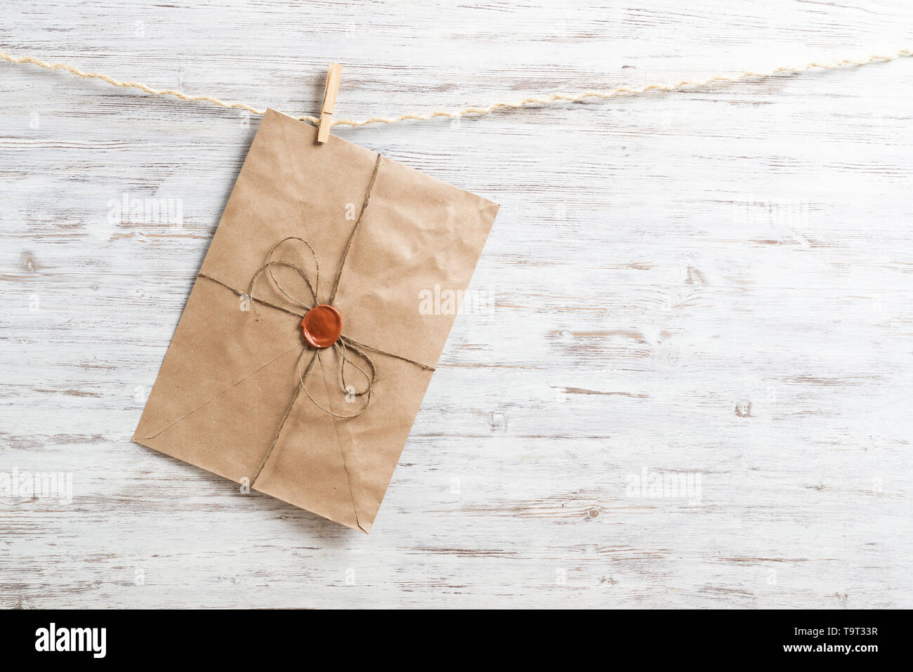Old paper envelope hanging on rope Stock Photo - Alamy