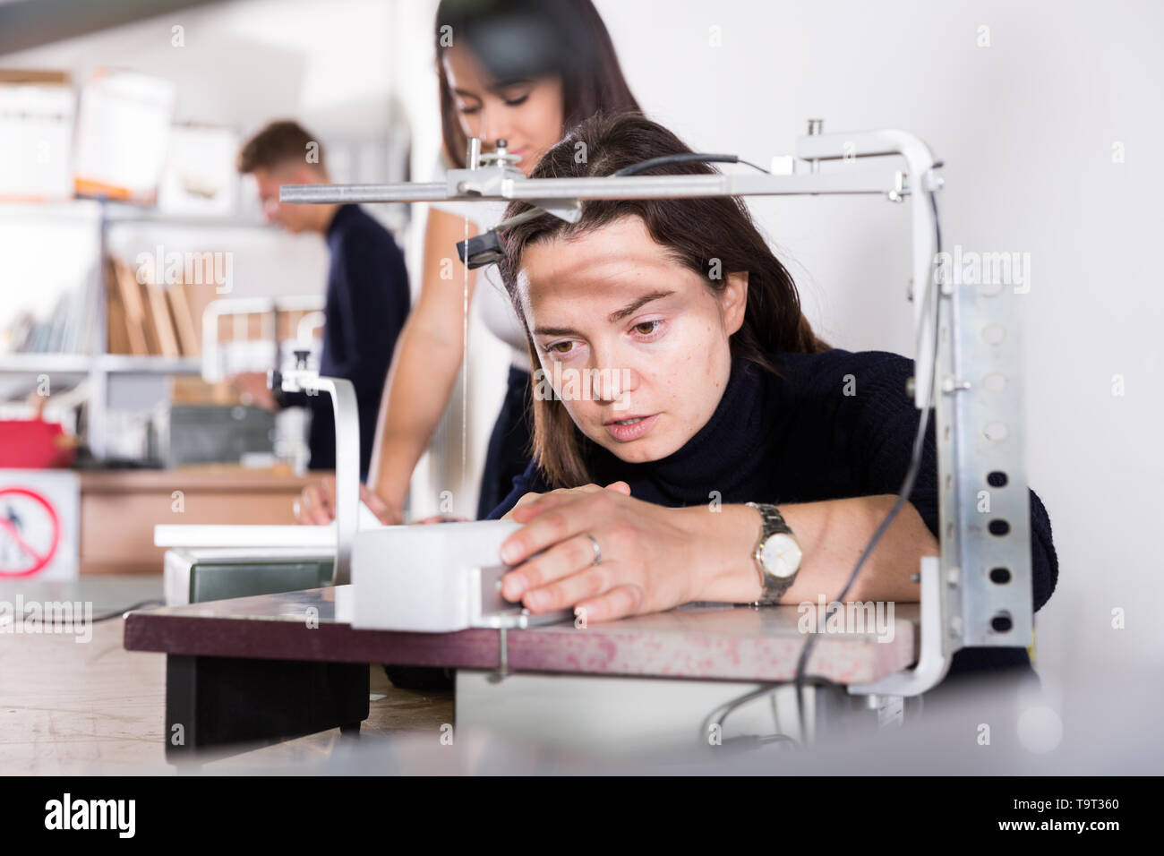 Female architect working on fret saw, creating details for new ...