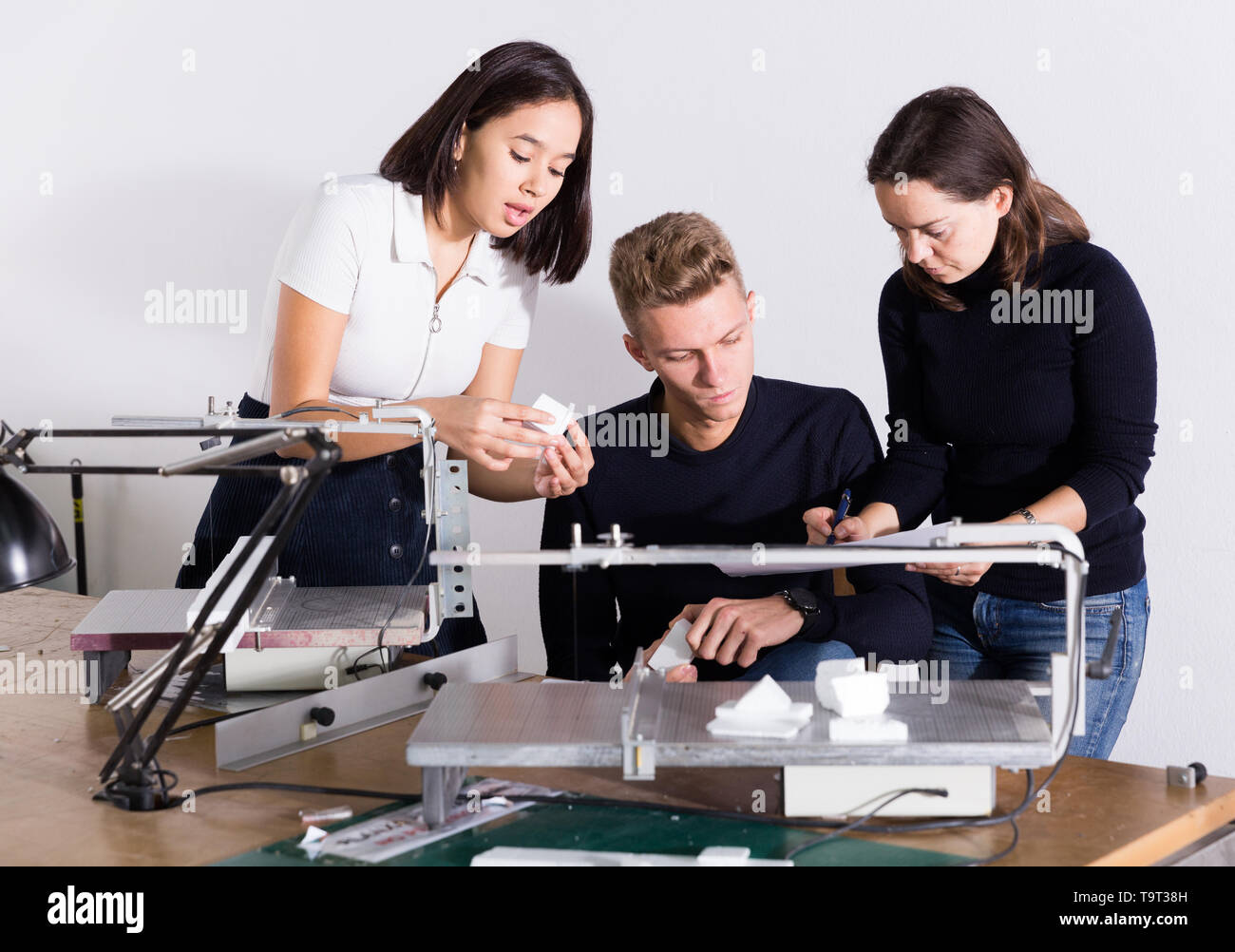 Students and teacher of architecture faculty discussing details of ...