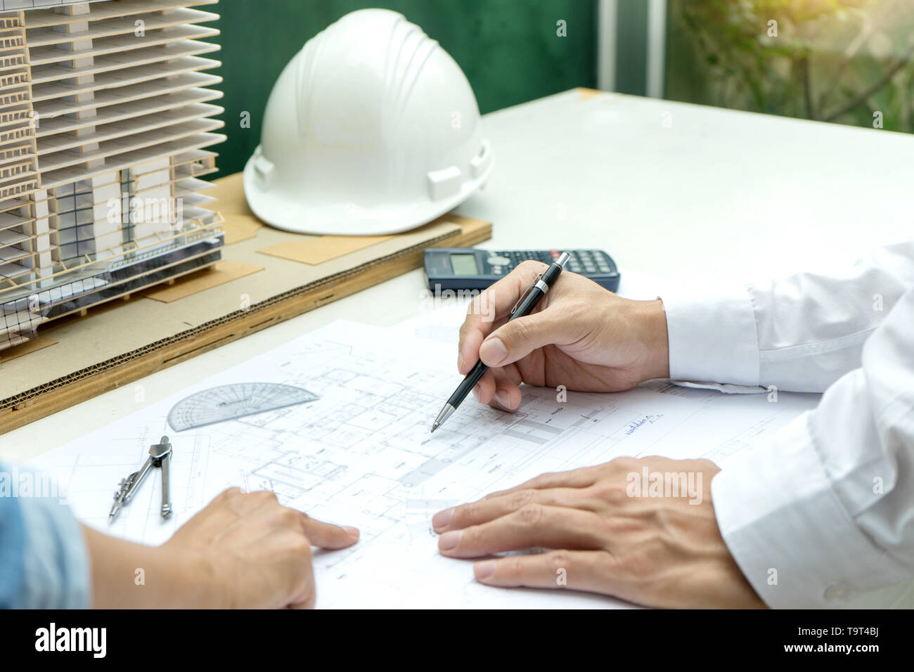 architect or engineer working on table show work man and woman for ...
