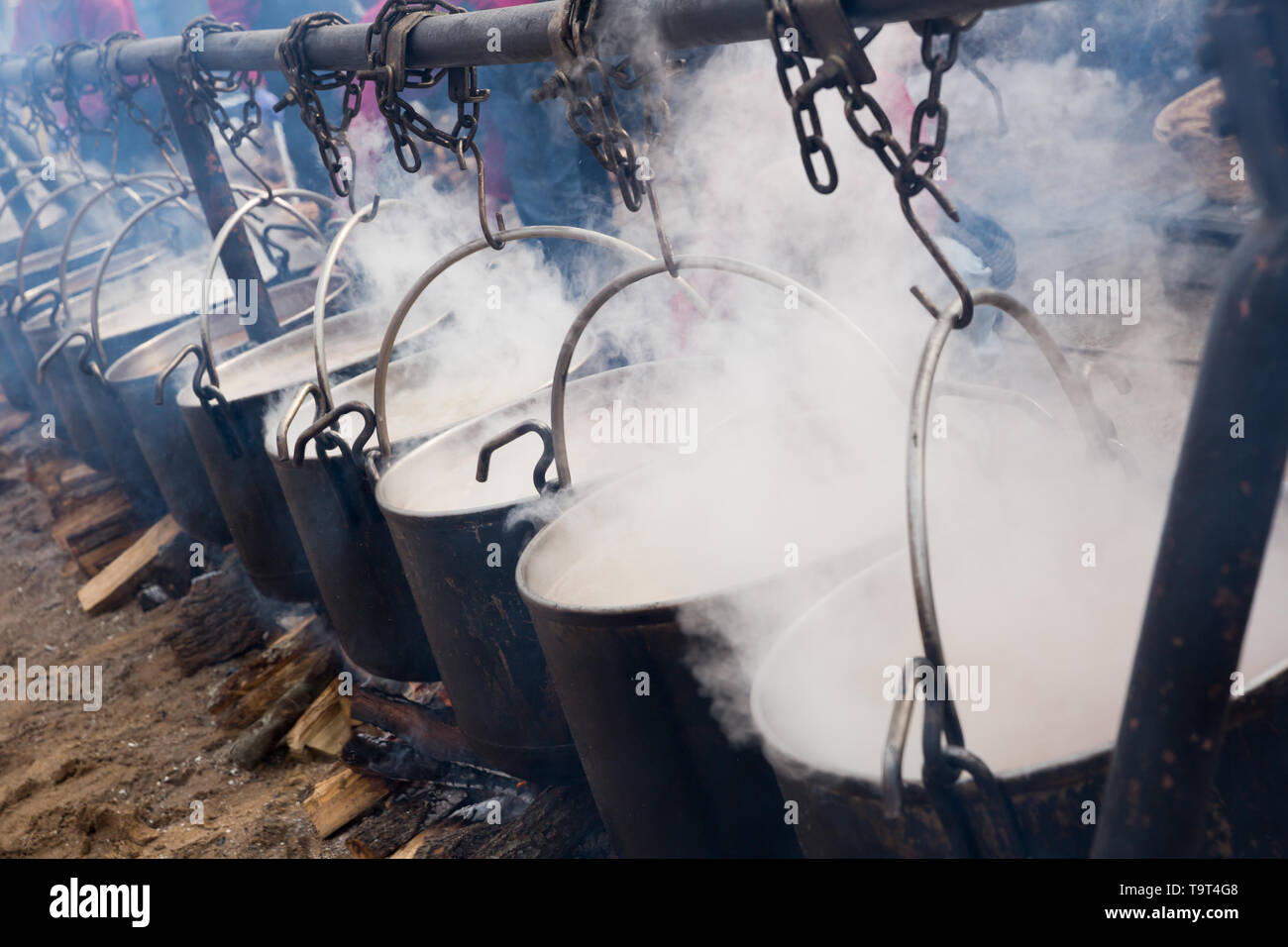 View of iron cauldrons for cooking outdoors in medieval style in open ...