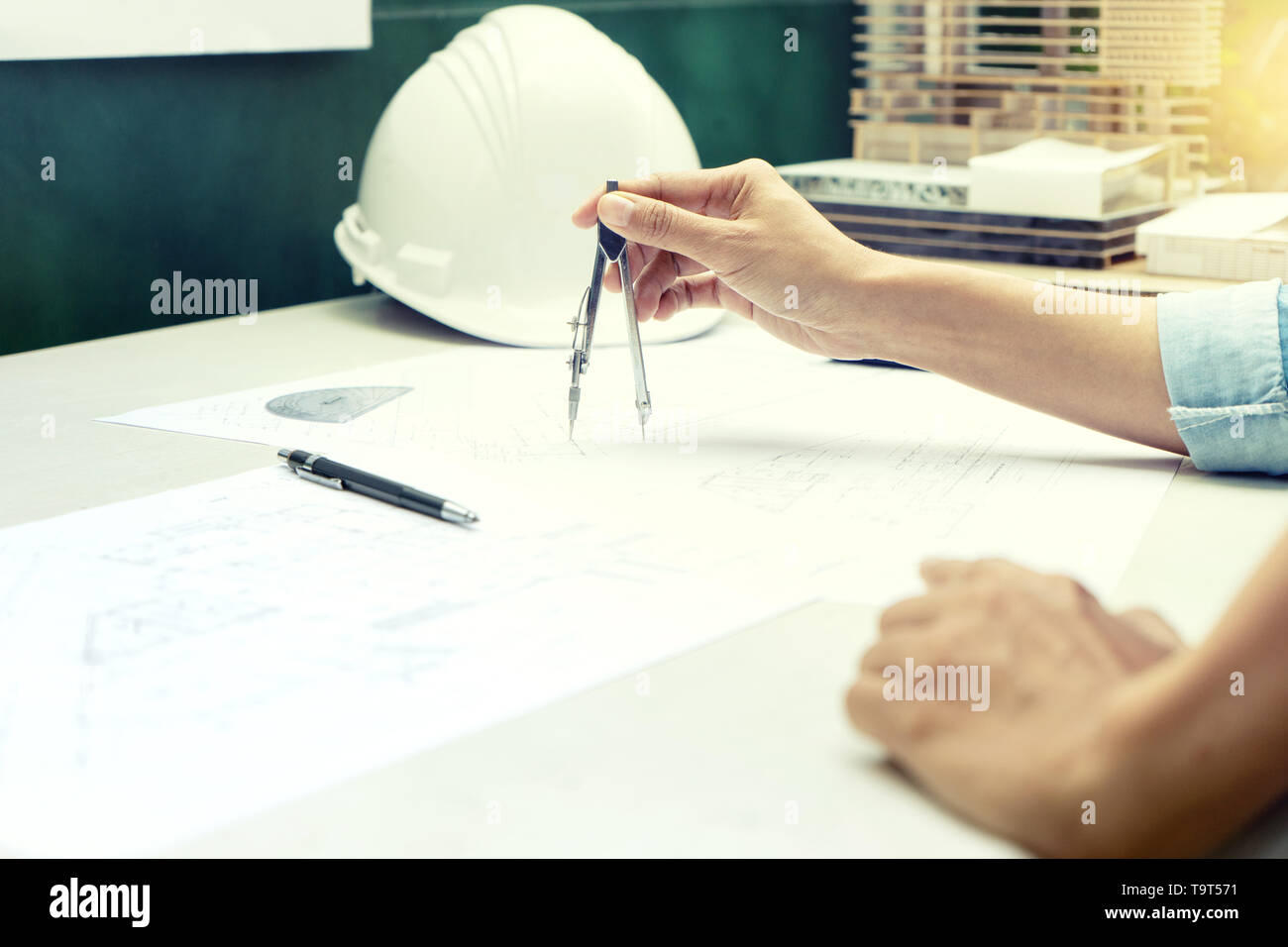 architect or engineer working on table show work man and woman for ...