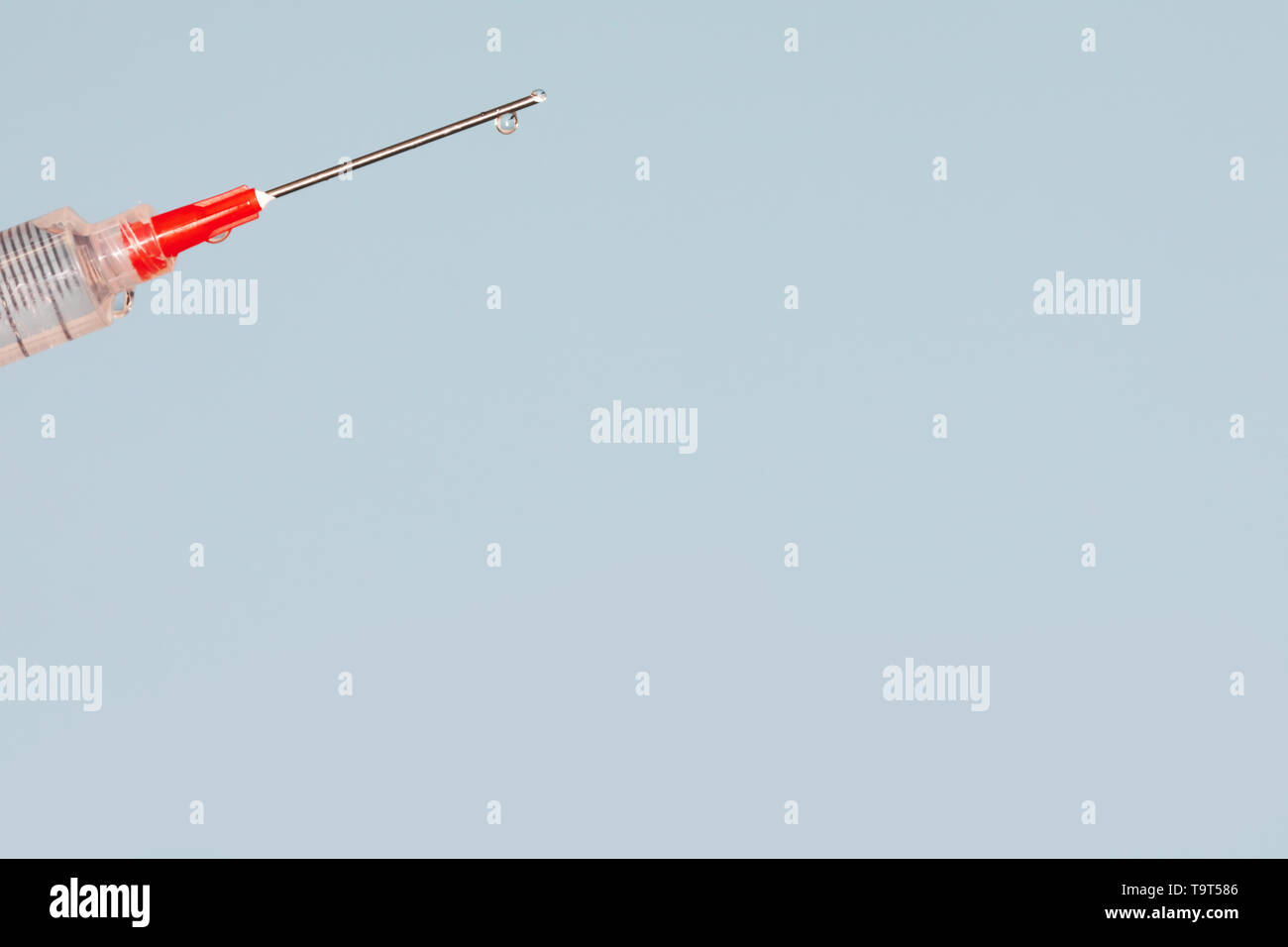 Syringe closeup isolated on blue background with drop, High resolution ...