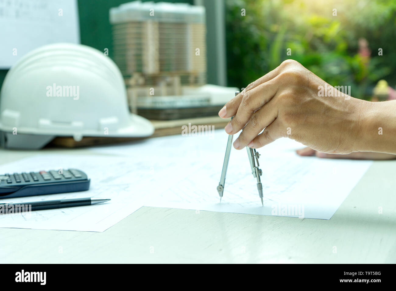 architect or engineer working on table show work man and woman for ...