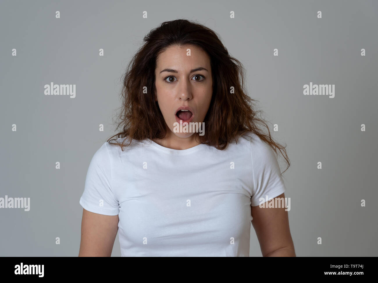 Beautiful young red hired woman with happy face making surprised ...