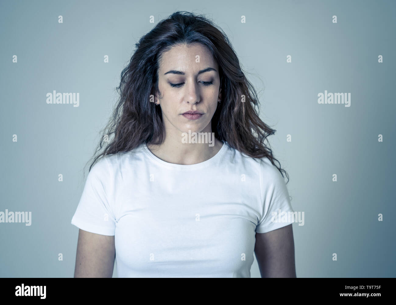 Portrait of young sad woman looking worried in emotional pain. Feeling ...
