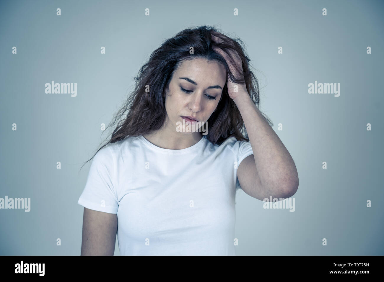 Portrait of young sad woman looking worried in emotional pain. Feeling ...