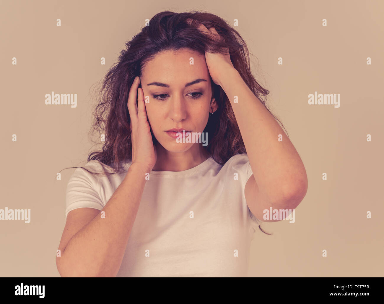 Portrait of young sad woman looking worried in emotional pain. Feeling ...