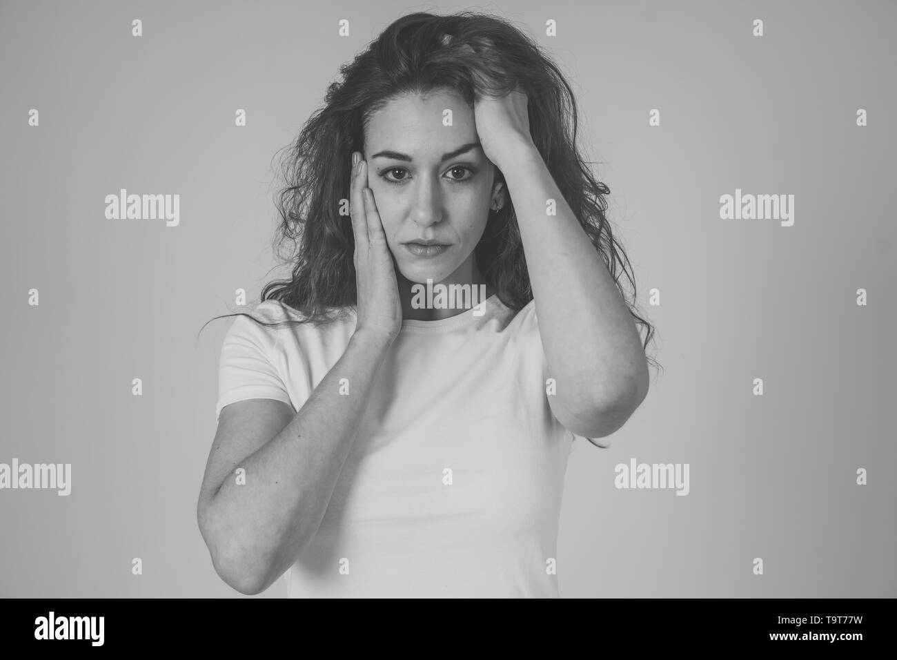 Close up portrait of a young woman looking worried and thoughtful ...