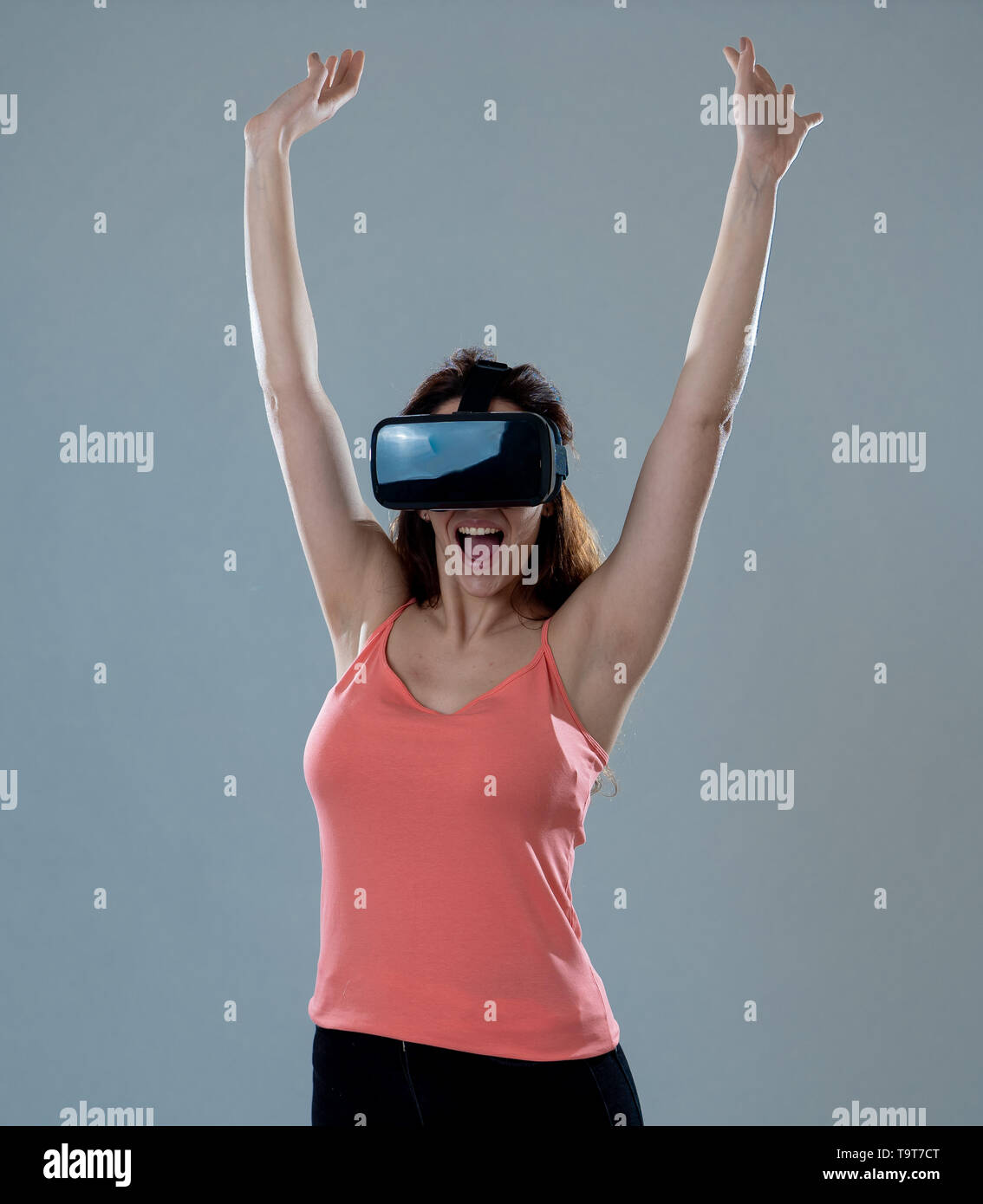 Curious woman happy and excited to use virtual reality goggles feeling ...
