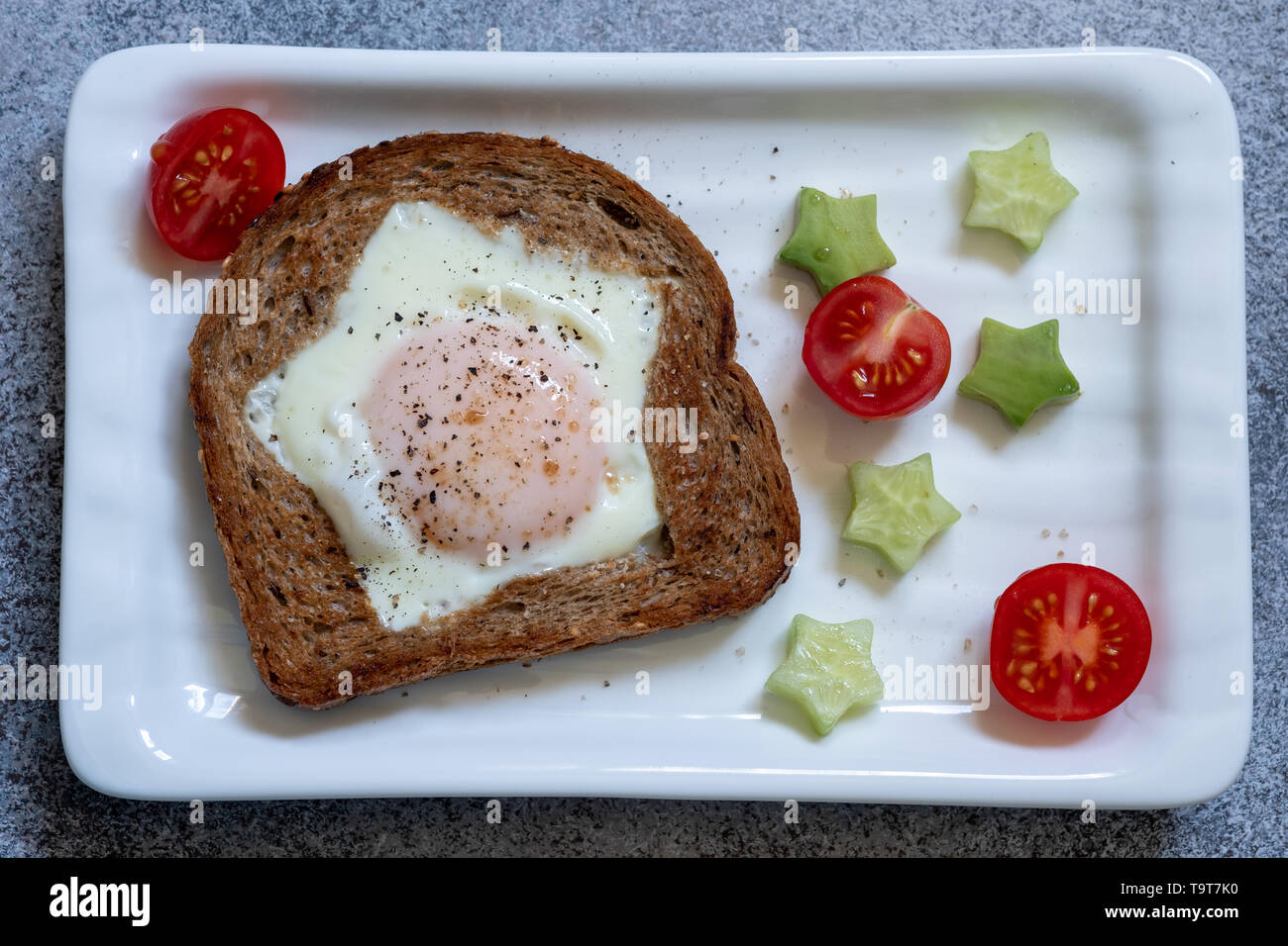 Egg fried in a hole star-shaped toast Stock Photo - Alamy