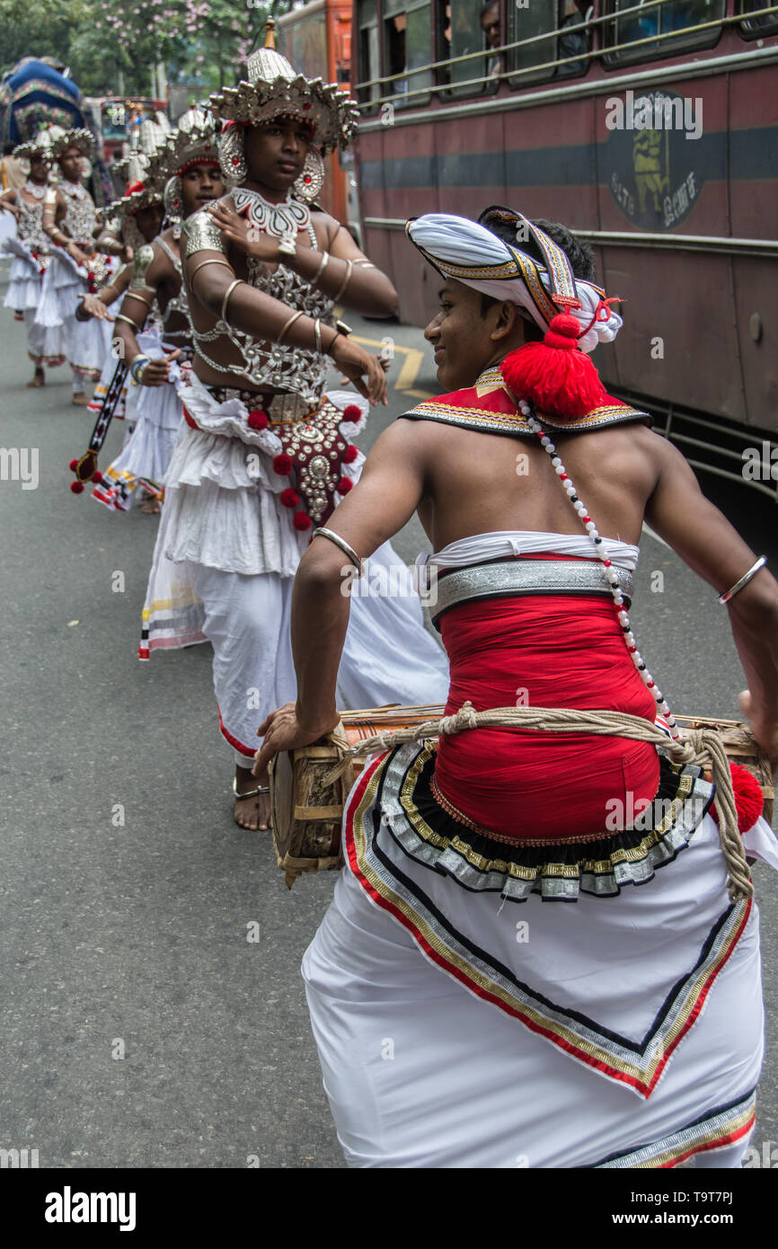 Traditional dancers parade through the streets of Kandy, Sri Lanka ...