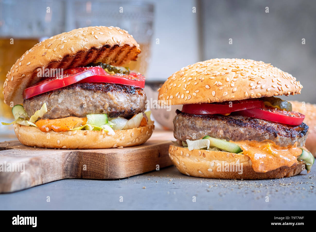 Two delicious homemade burger with beef, tomatoes and cucumber Stock ...