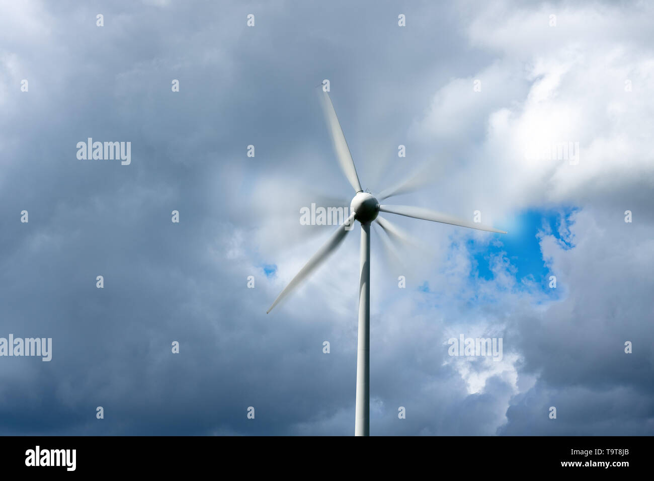 wind turbine windmill with motion blur and cloudy sky Stock Photo - Alamy