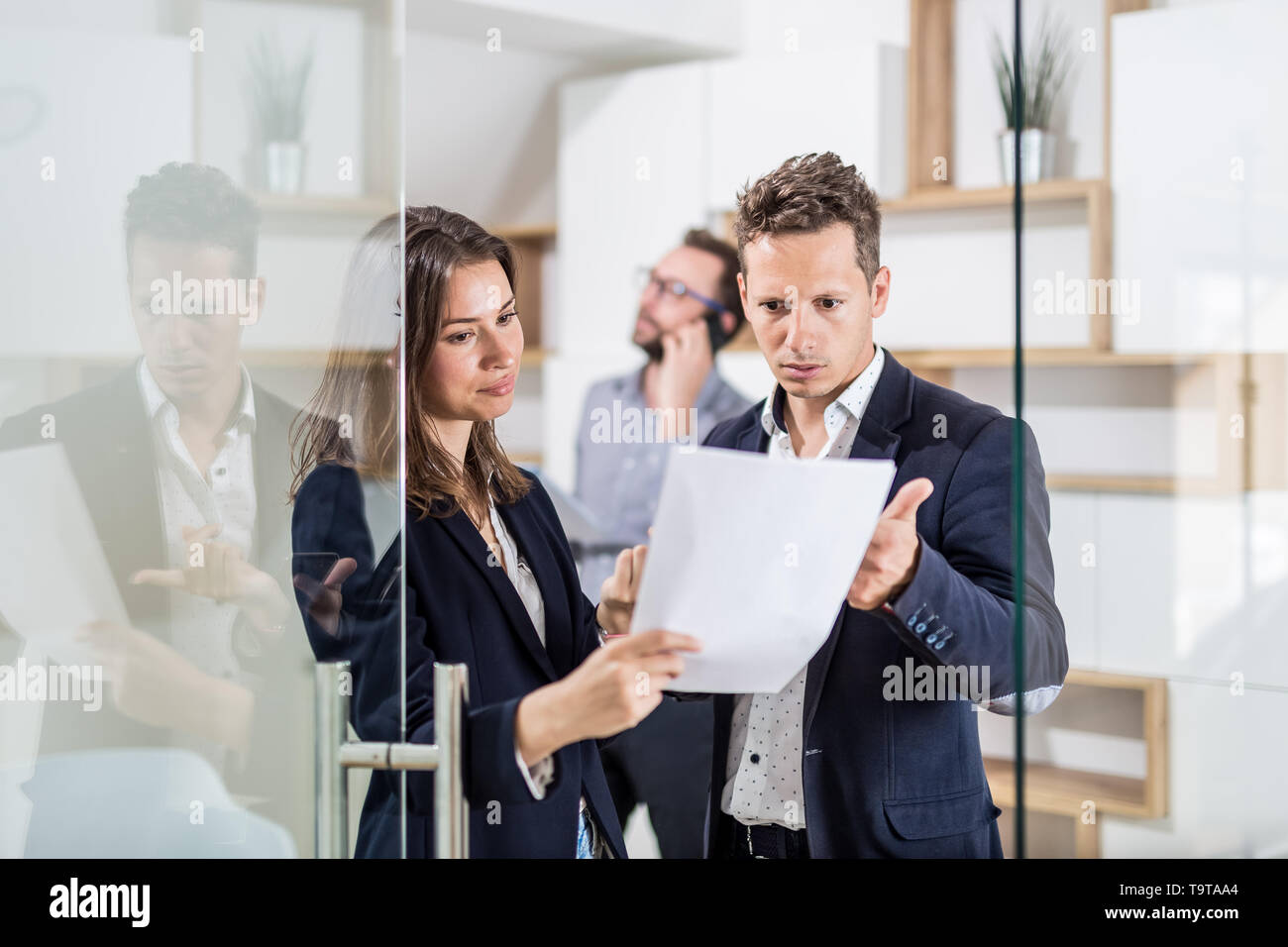 Manager arguing with his female employee next to office door Stock ...