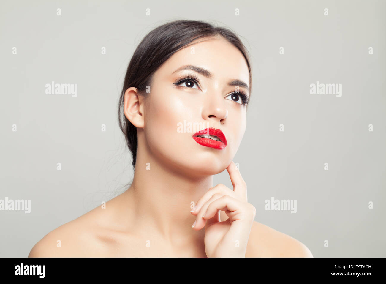 Beautiful woman thinking on white background Stock Photo - Alamy