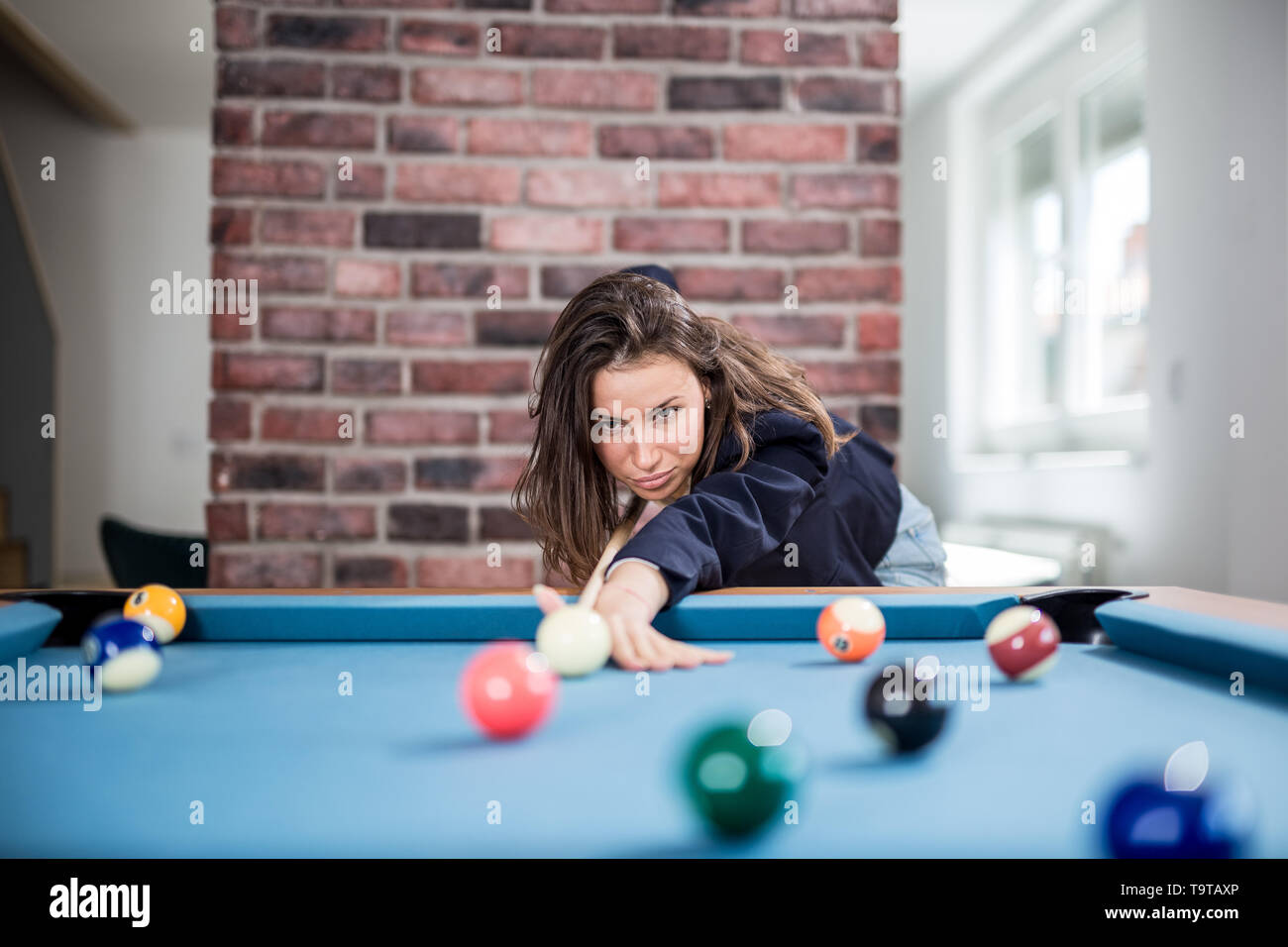 Fashionable modern woman playing pool table billiards game Stock Photo ...