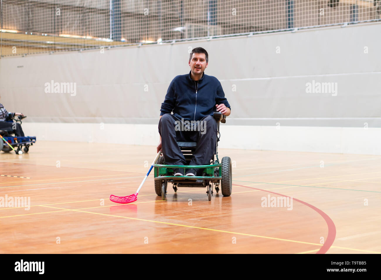 Disabled man on an electric wheelchair playing sports, powerchair ...